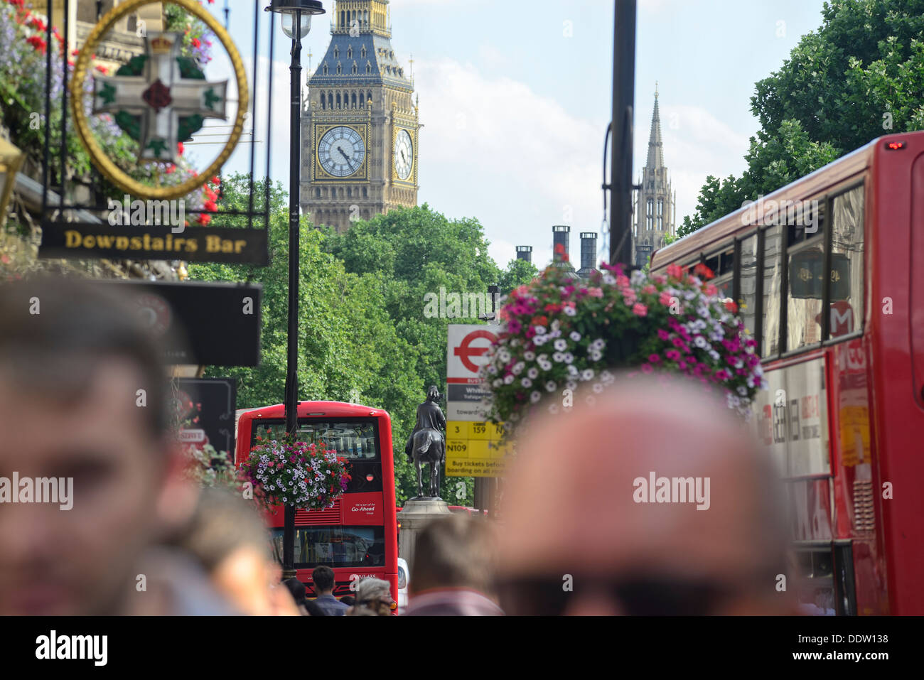 Typical red double decker buses heading towards Big Ben, one of major ...