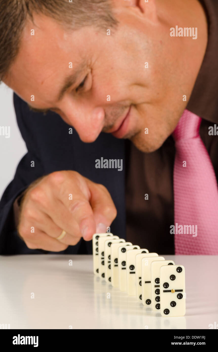 Guy having fun causing a chain reaction, a concept Stock Photo - Alamy