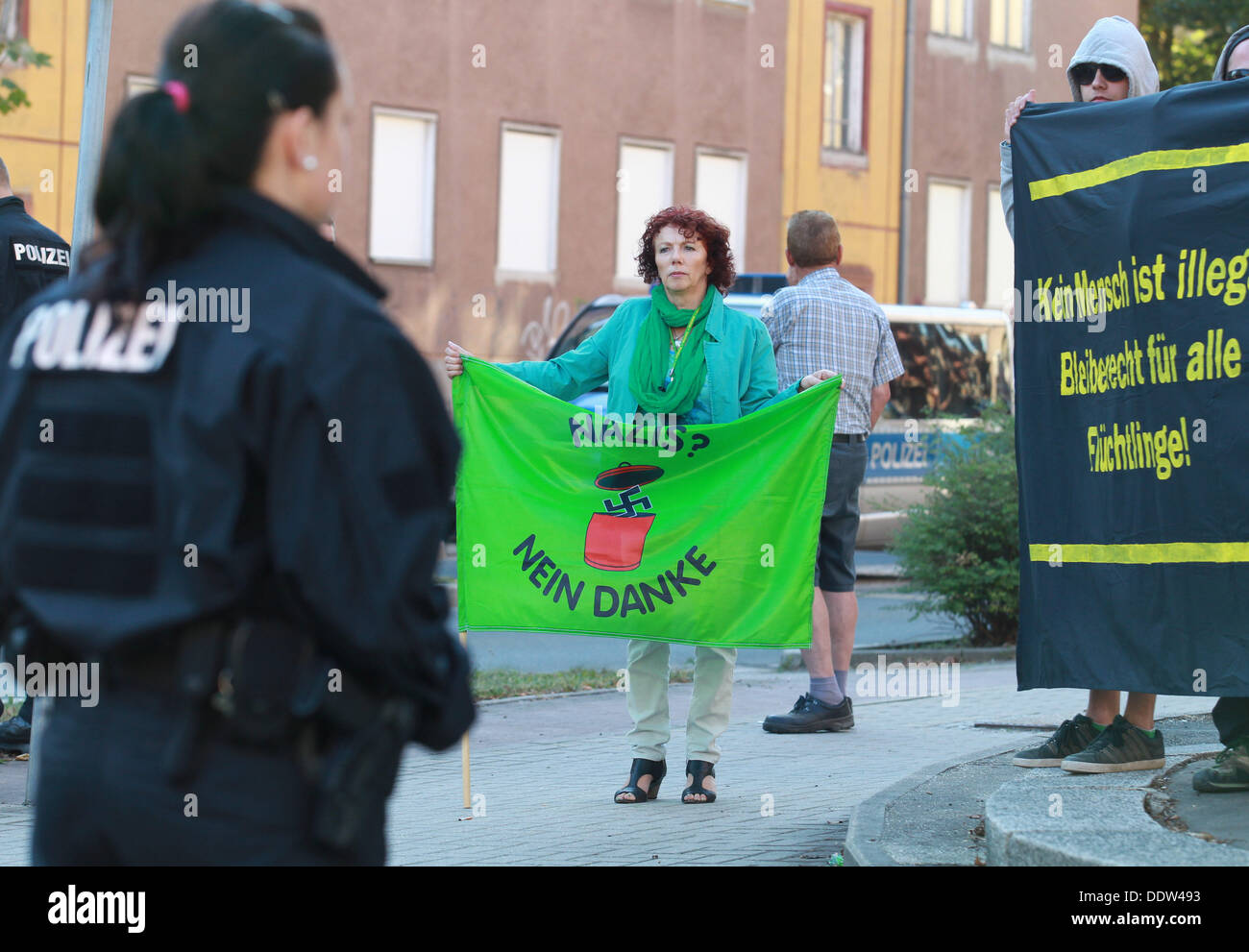 Members of a left action association and police officers stand in front ...