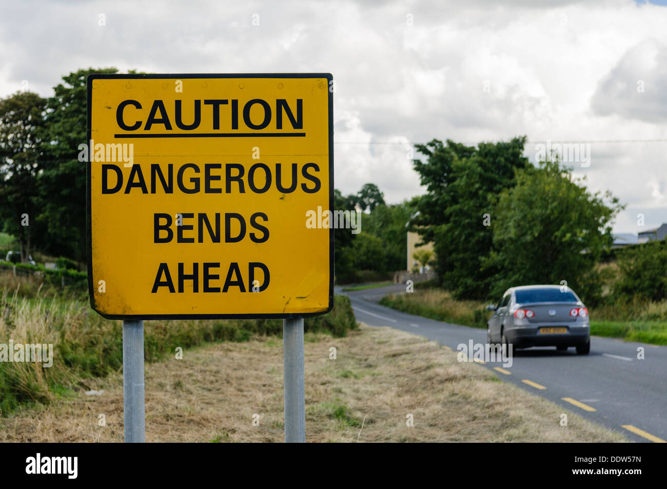 Sign warning drivers of dangerious bends ahead Stock Photo - Alamy