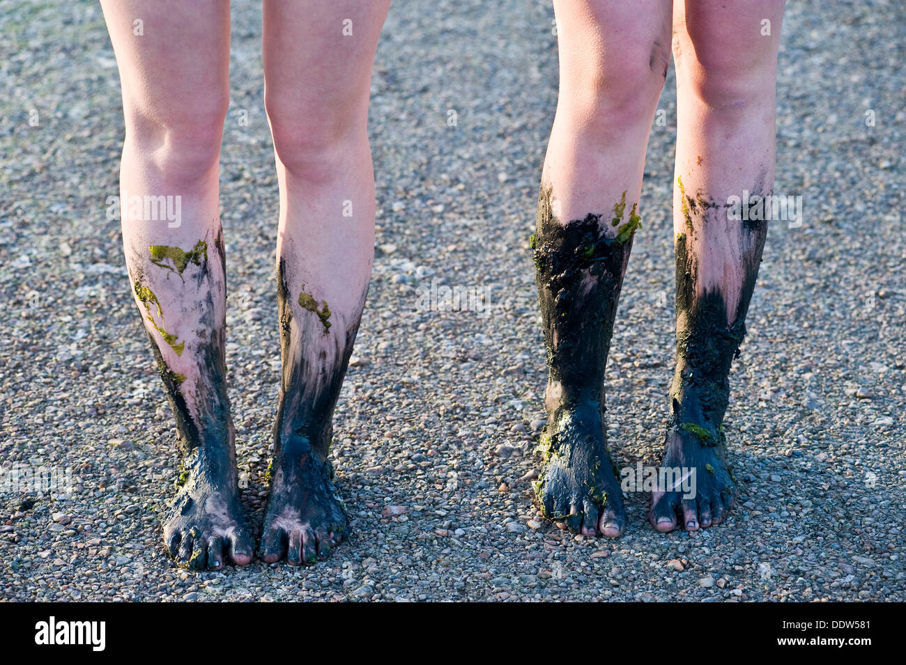 Two sets of muddy feet Stock Photo - Alamy