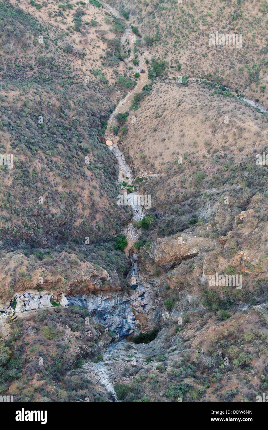 Aerial view of dry rocky river bed and surrounding slopes in Lewa Downs ...