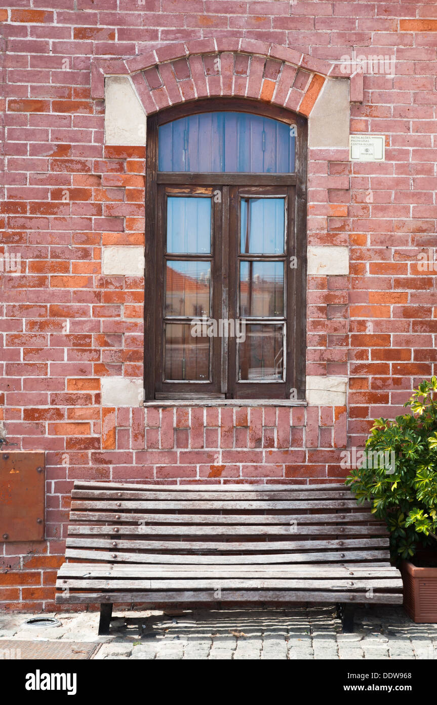 Bench, window and brick wall Stock Photo - Alamy