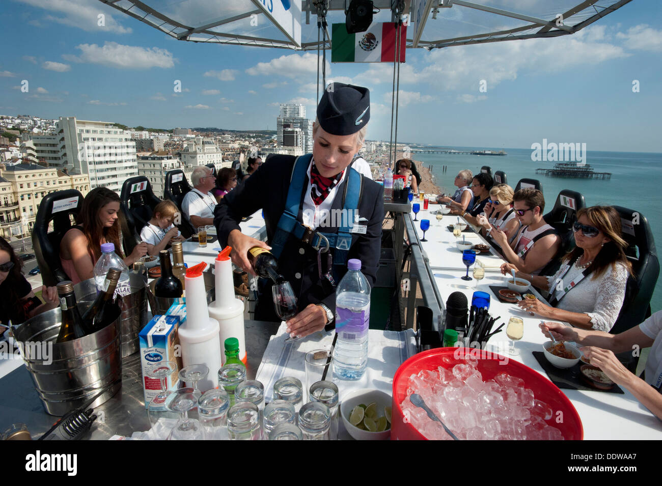 A British Airways Stewardess serves drinks to diners 100 foot high in ...