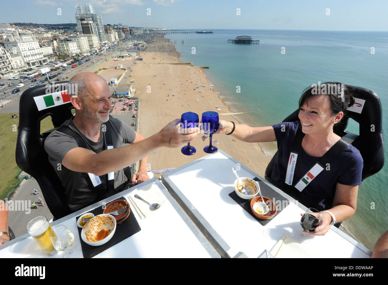 Diners enjoy eating at a high-flying dining table dangling from a crane ...