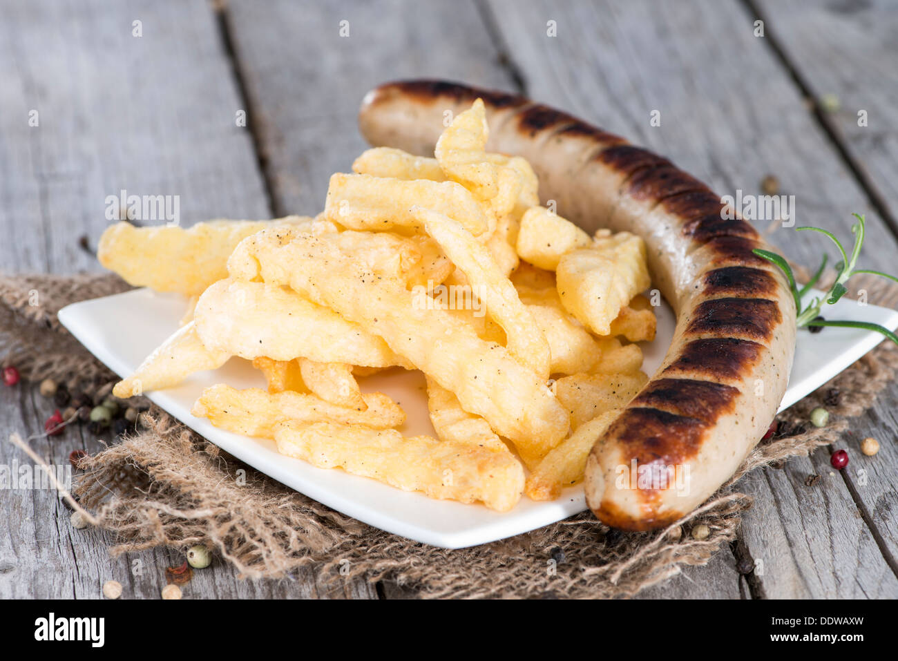 Original German Bratwurst with portion of French Fries Stock Photo - Alamy