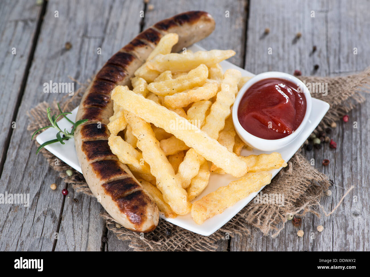Original German Bratwurst with portion of French Fries Stock Photo - Alamy