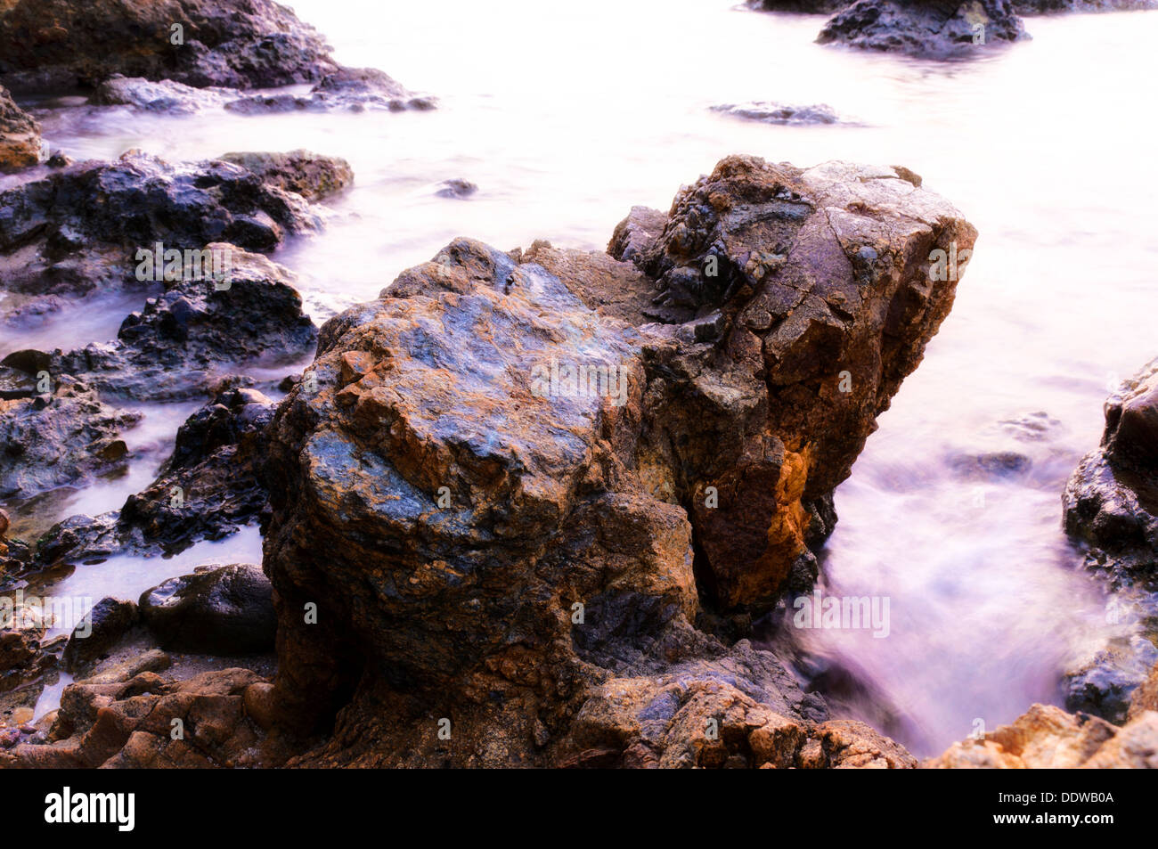 Big stone and sea water in long exposure Stock Photo - Alamy