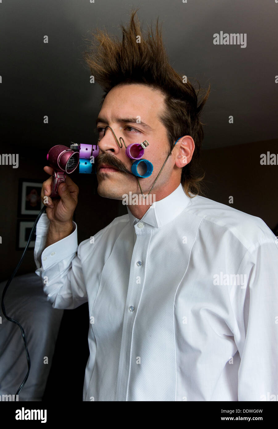 New Orleans, Louisiana, USA. 07th Sep, 2013. BROOKE MAHNKEN blow dries his moustache, which is ...