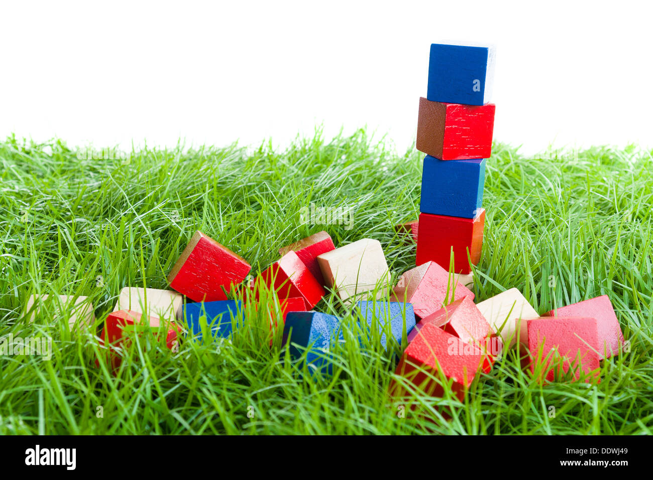 Small house of children's blocks on the grass Stock Photo - Alamy