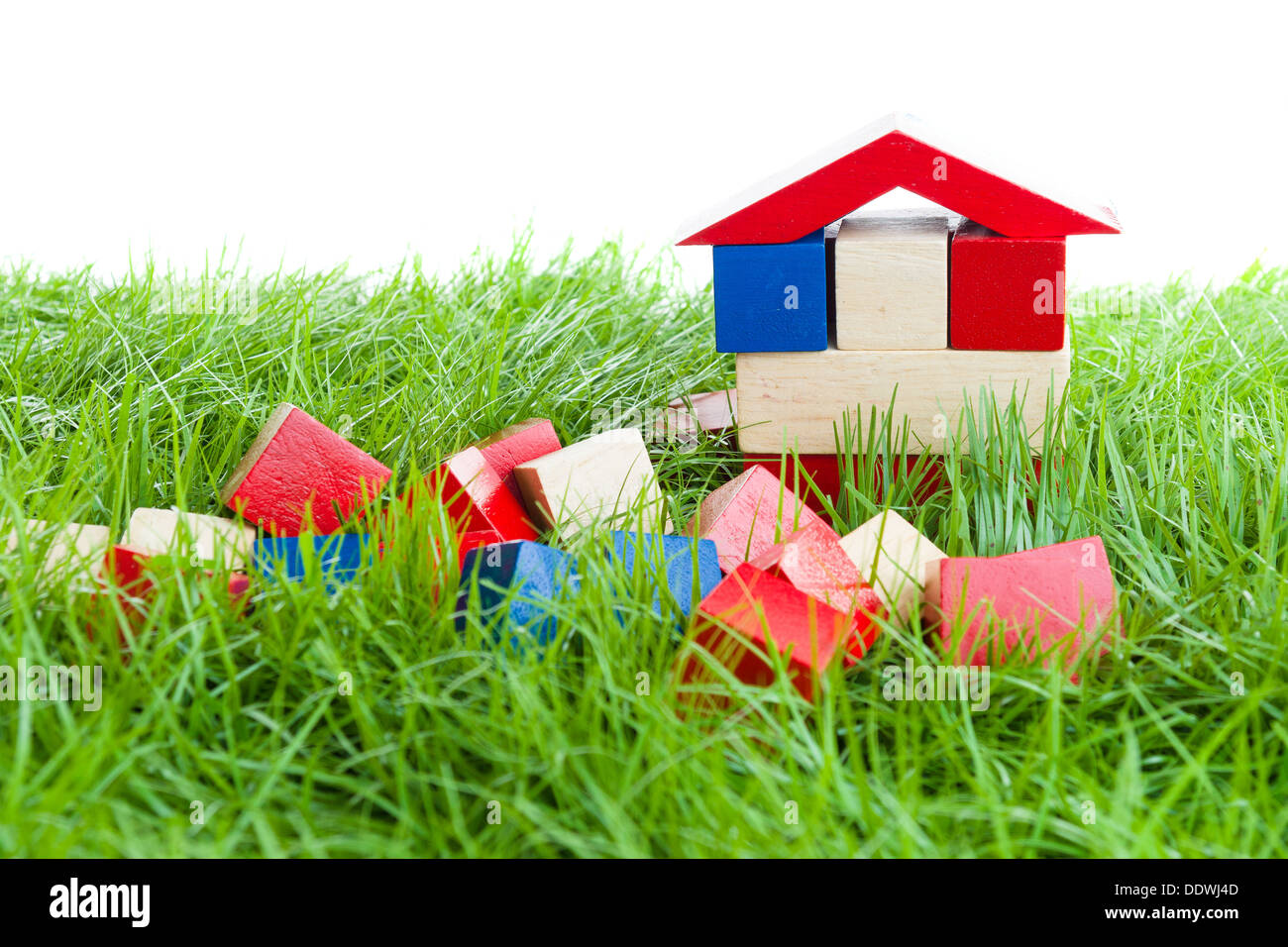 Small house of children's blocks on the grass Stock Photo - Alamy