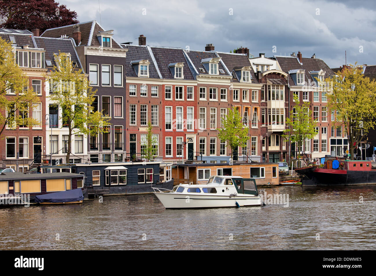 Amsterdam river view, houses and houseboats on the Amstel river in ...