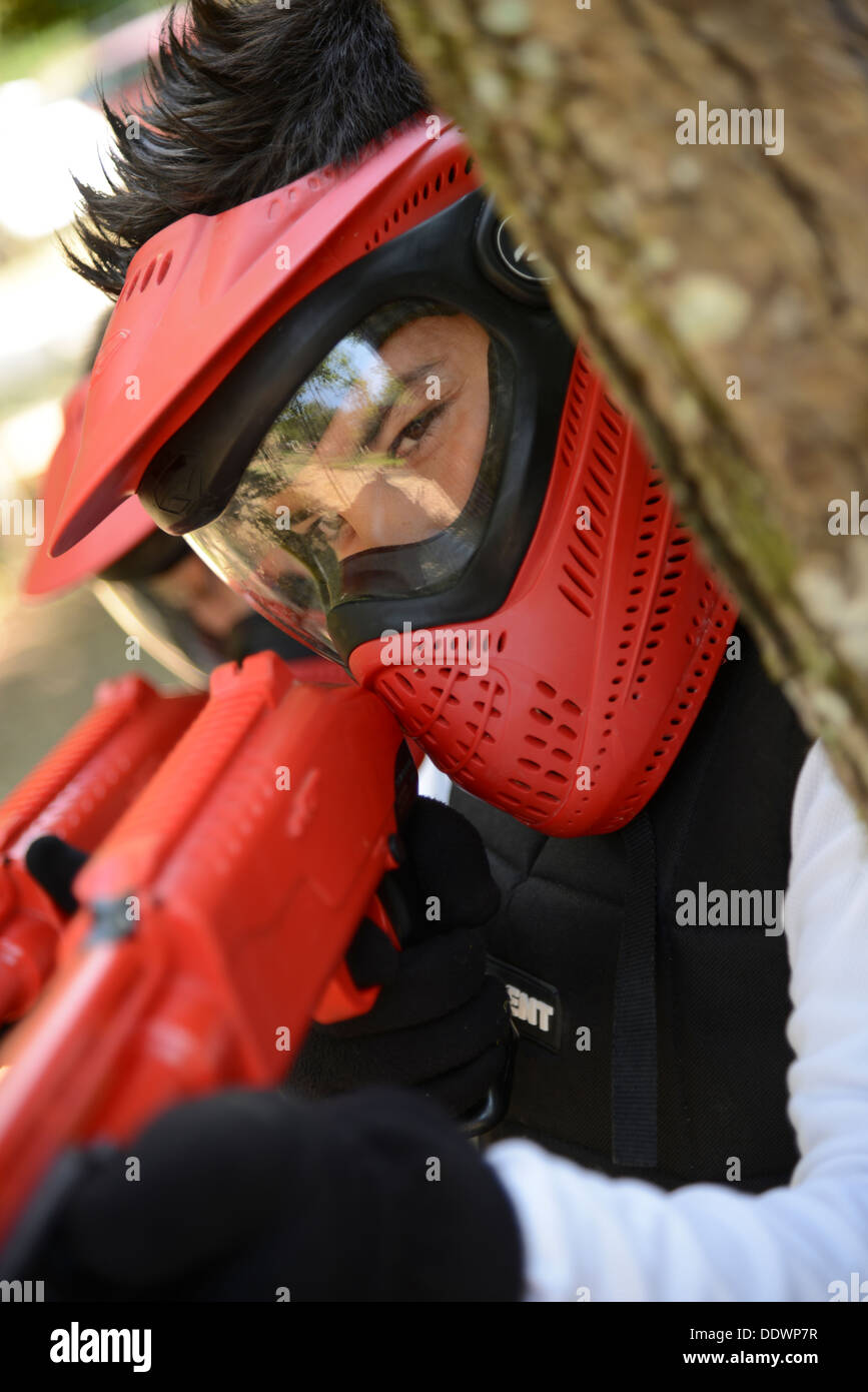Young children playing paintball in the woods Stock Photo - Alamy