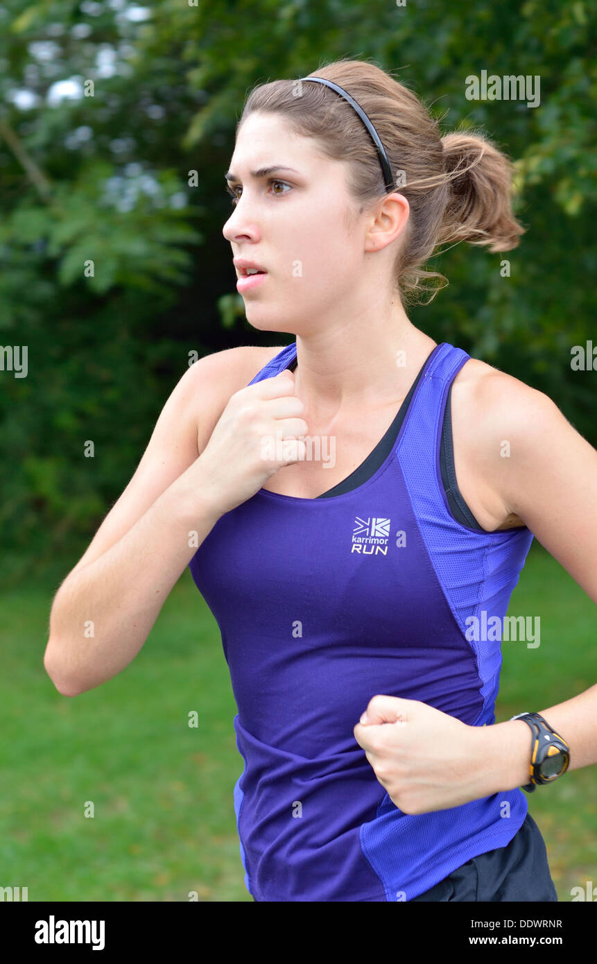 Young athletic woman running down a path towards camera Stock Photo - Alamy