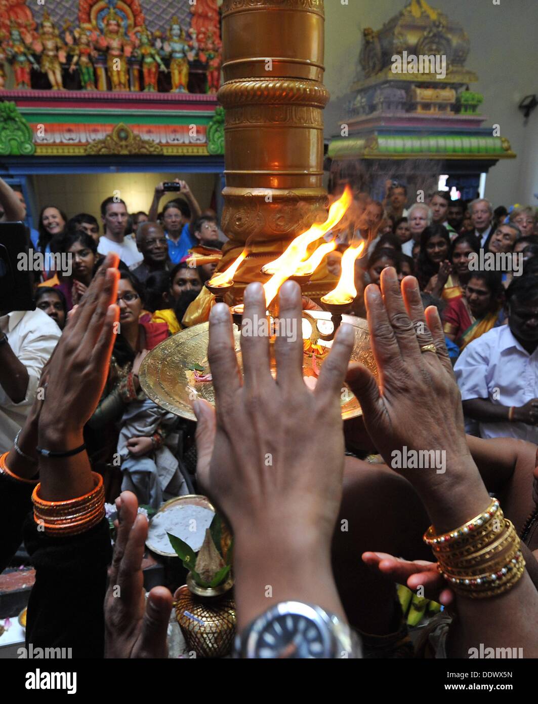 Hindus take part in a cleaning ritual during opening of a Hindu temple ...