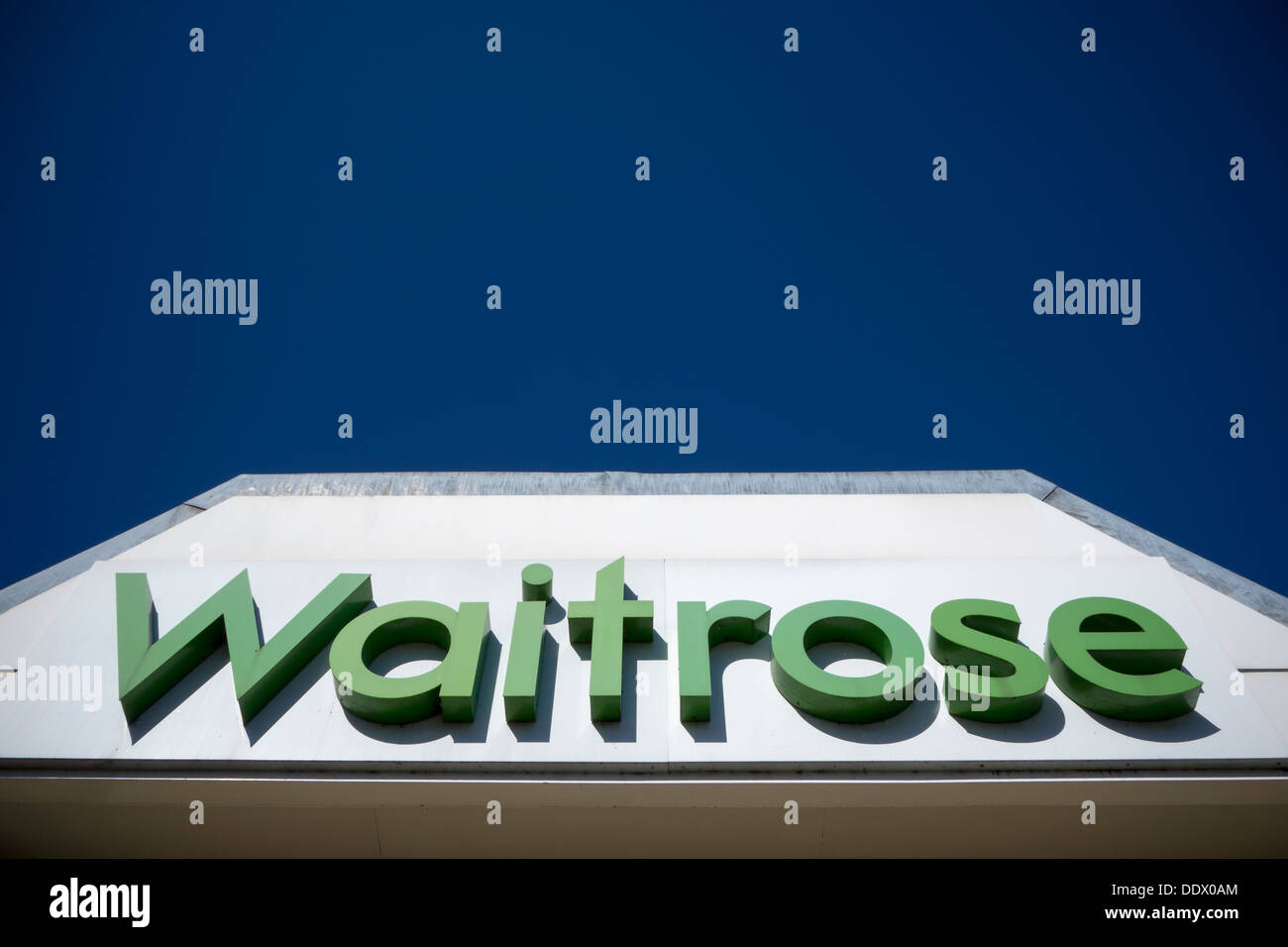A Waitrose store's sign, with a clear blue sky as backdrop Stock Photo ...