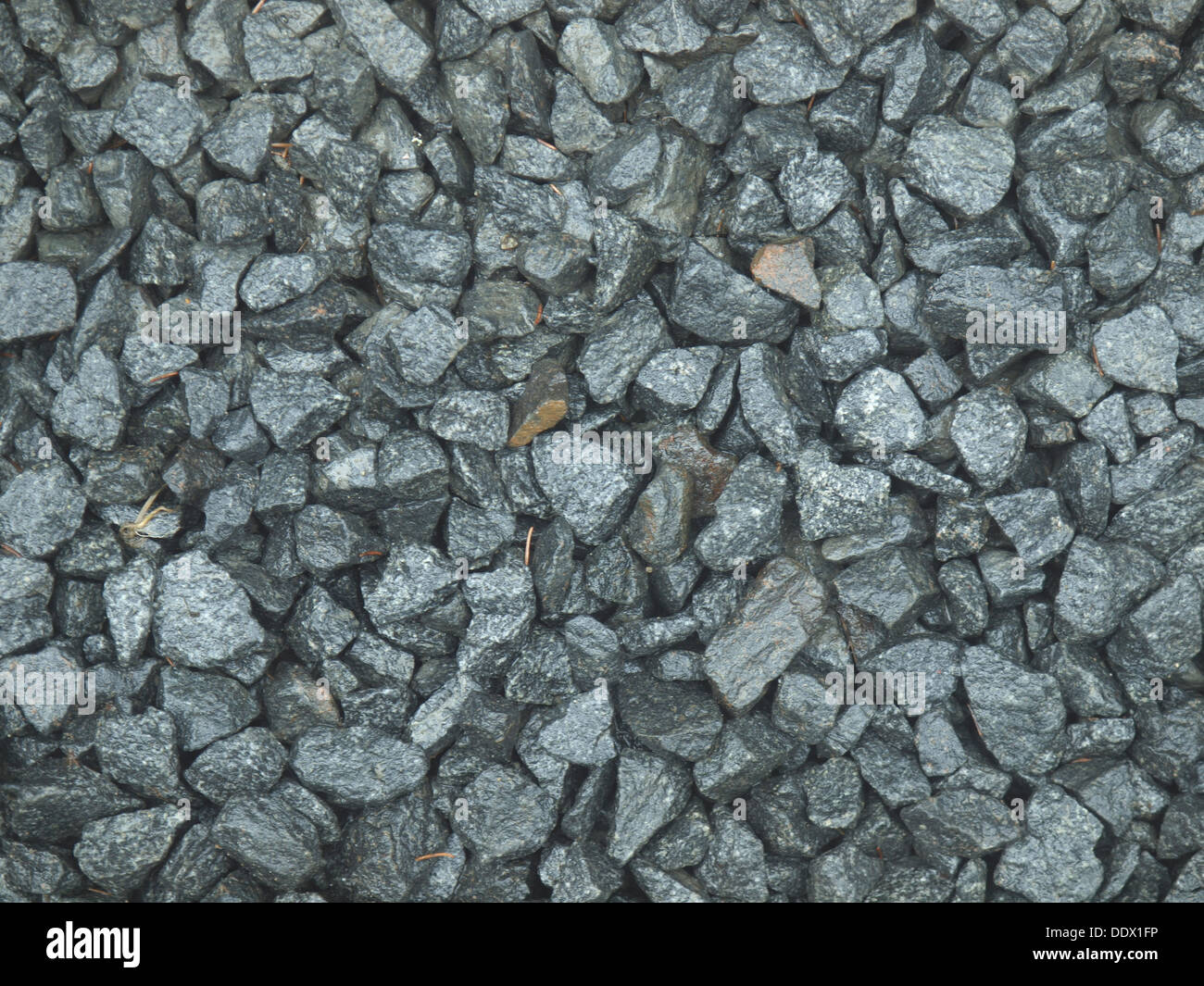Wet dark stone gravel. A background Stock Photo - Alamy