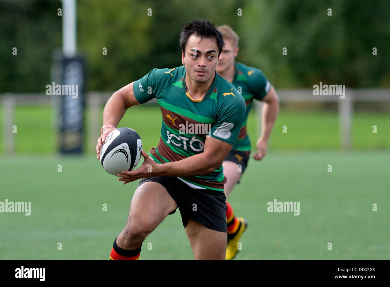 a bradford and bingley player runs with the ball in a rugby match ...