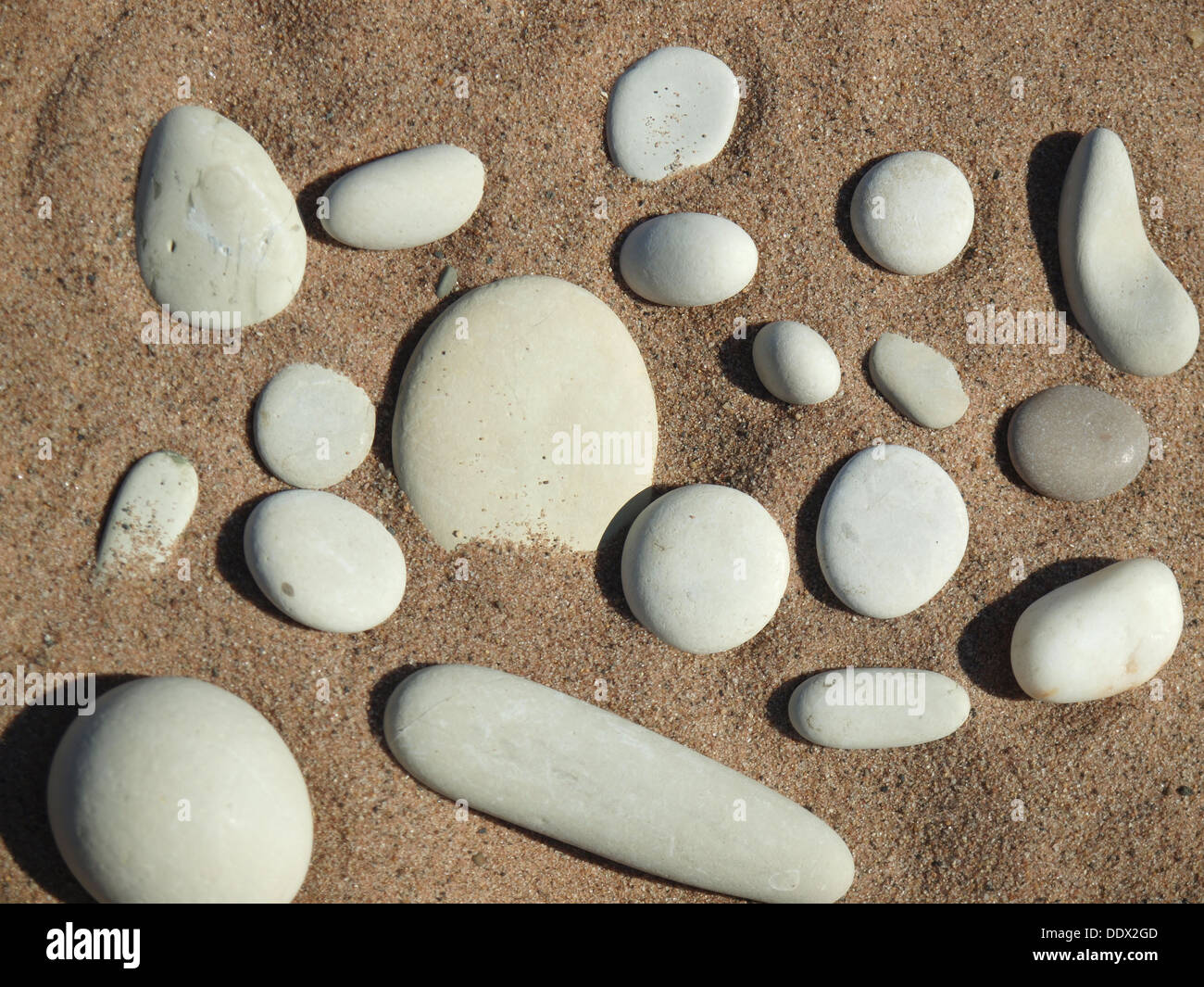White pebble on sand on coast of lake Stock Photo - Alamy