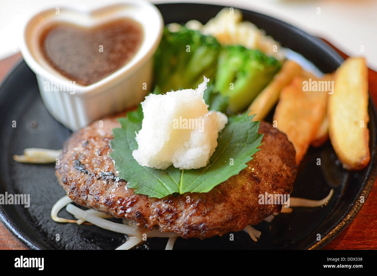 A hamburger Japanese style (hamburg). On top is grated Japanese radish ...