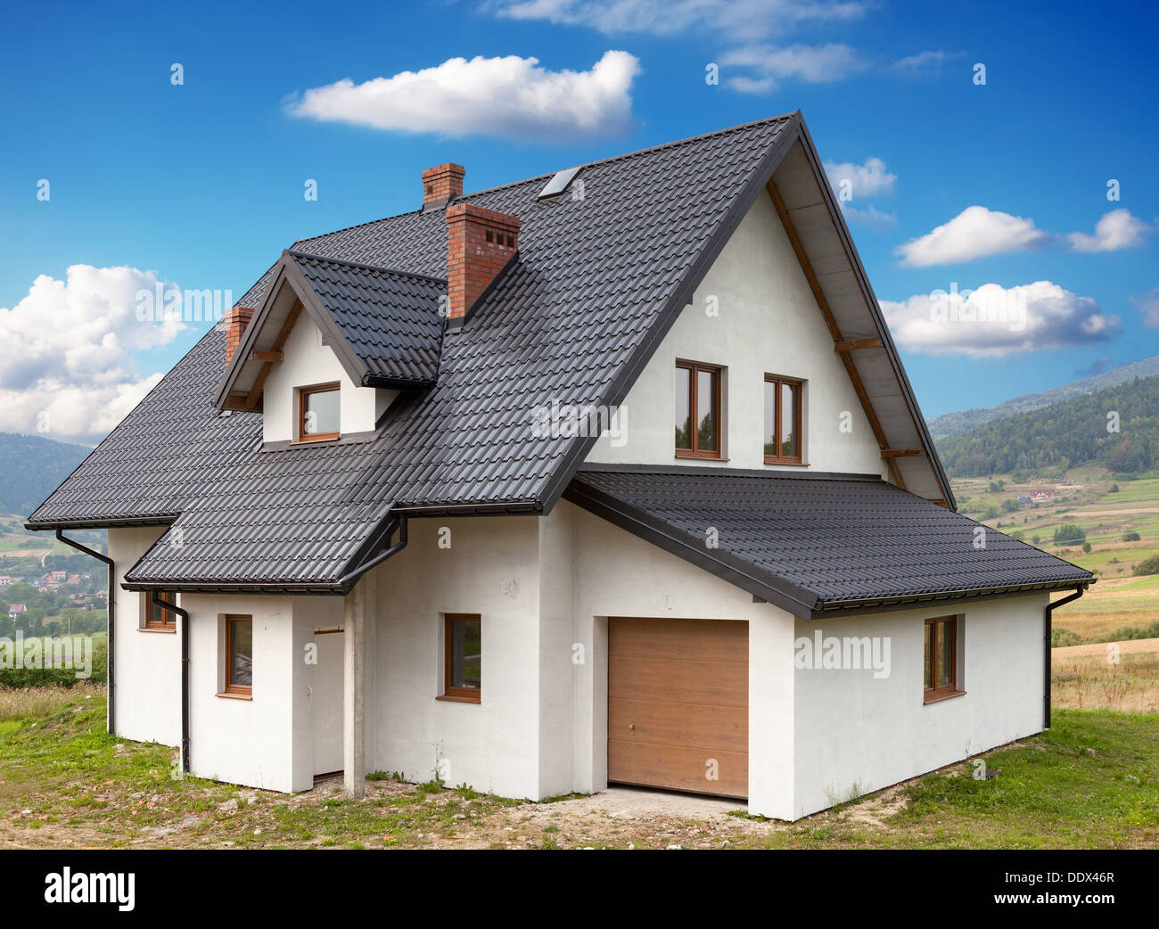 A new house with a garage in a rural area Stock Photo - Alamy