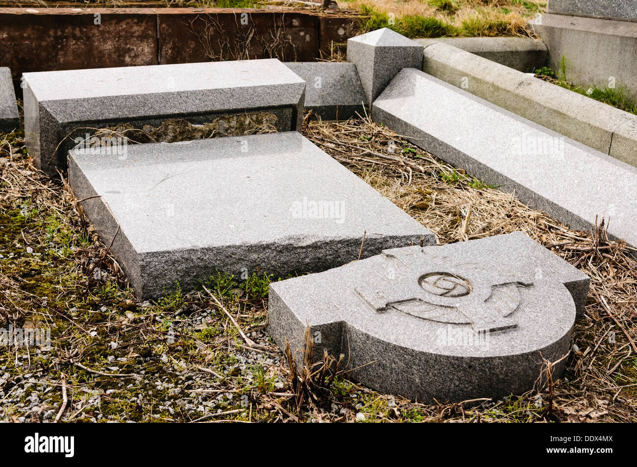 Broken gravestone in a cemetery after it has been vandalised Stock Photo - Alamy