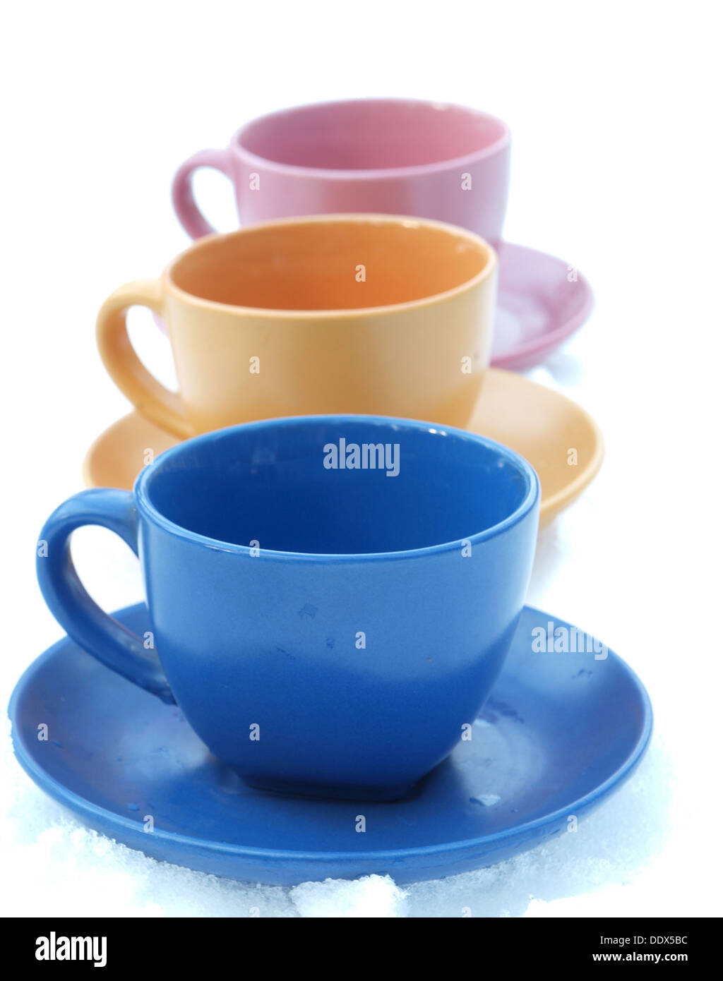 Violet, orange and blue cups on a snow Stock Photo - Alamy