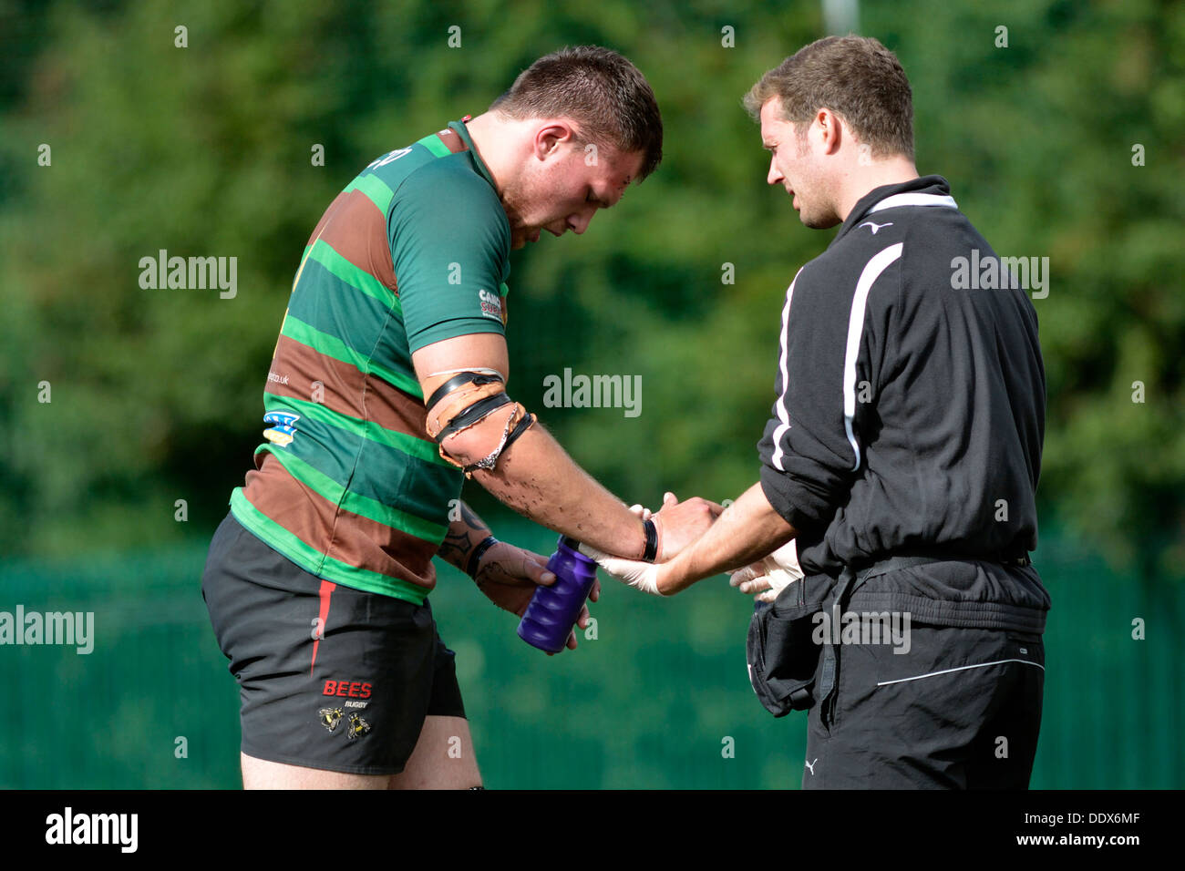 a bradford and bingley player has his injured hand bandaged in a rugby ...