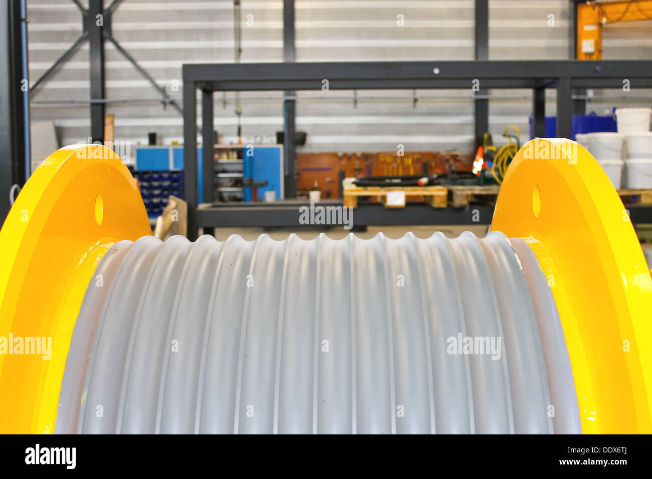 Empty drum for winding wire in the workshop Stock Photo - Alamy