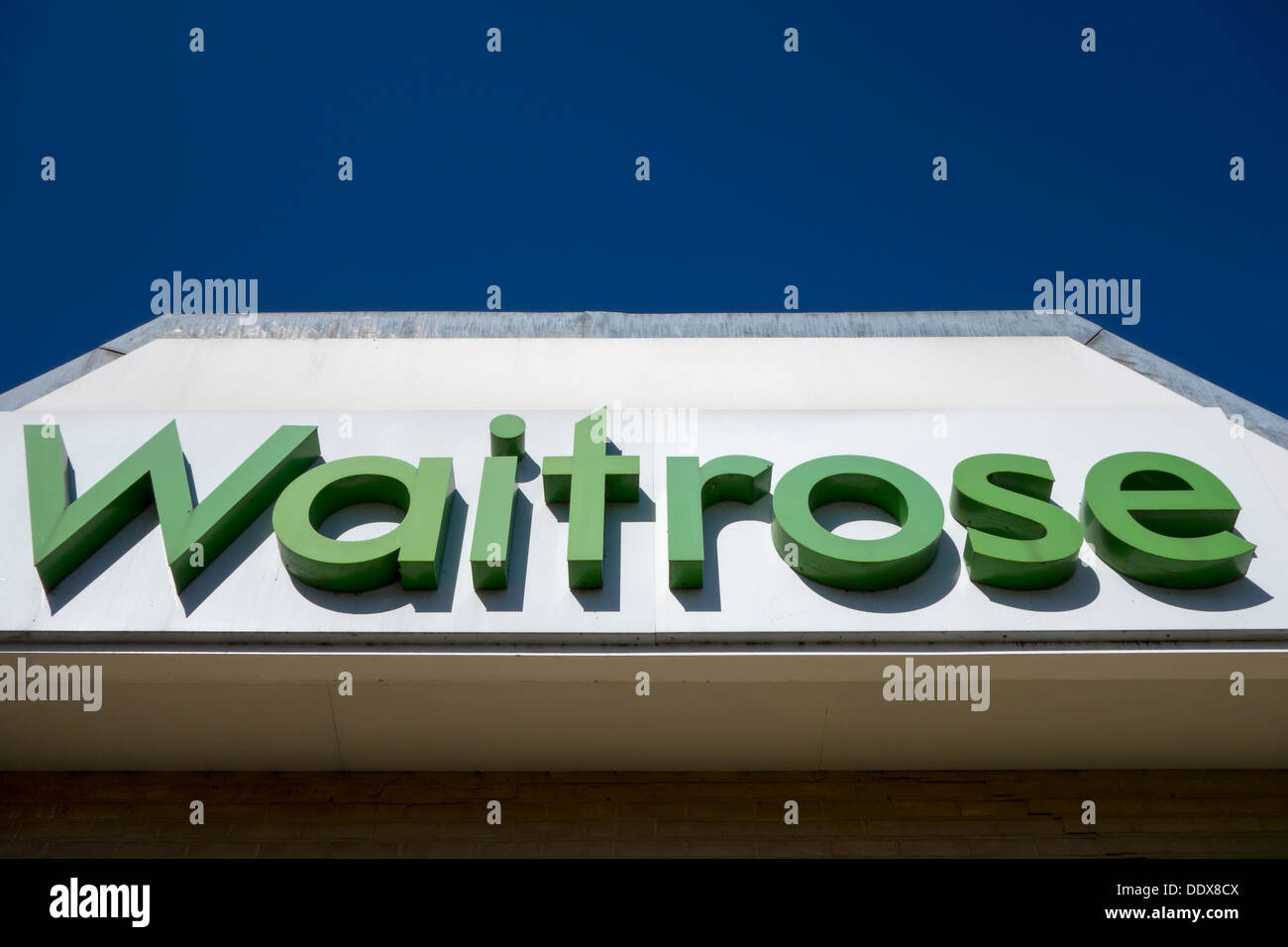 A Waitrose store's sign, with a clear blue sky as backdrop Stock Photo ...