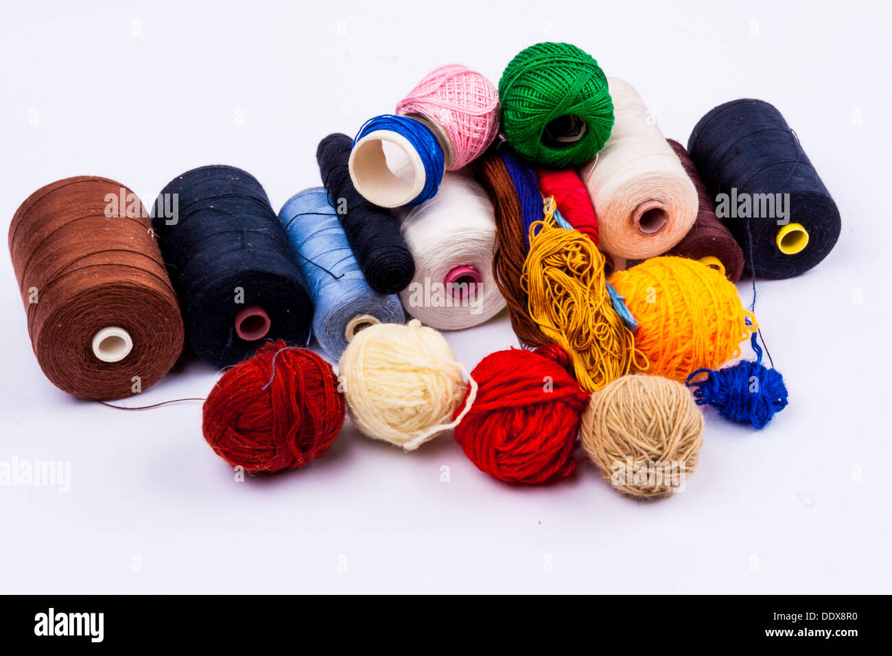 Colourful threads and wool on white background Stock Photo - Alamy
