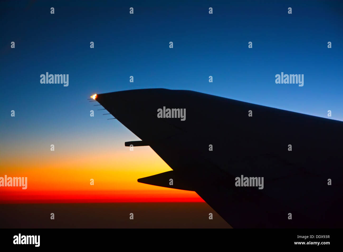 Airplane flight in sunrise Stock Photo - Alamy