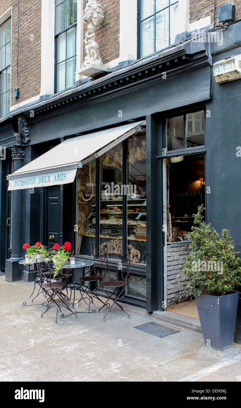 Traditional trendy cafe in Central London with red flowers and outdoor ...