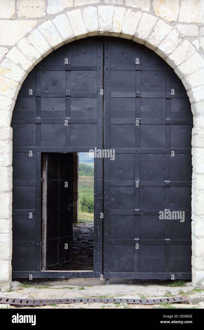 Big iron gates with opened door in the castle Stock Photo - Alamy