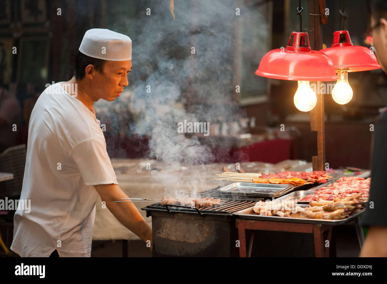 Hui muslim prepares street food at famous Muslim Street in Xian, China ...