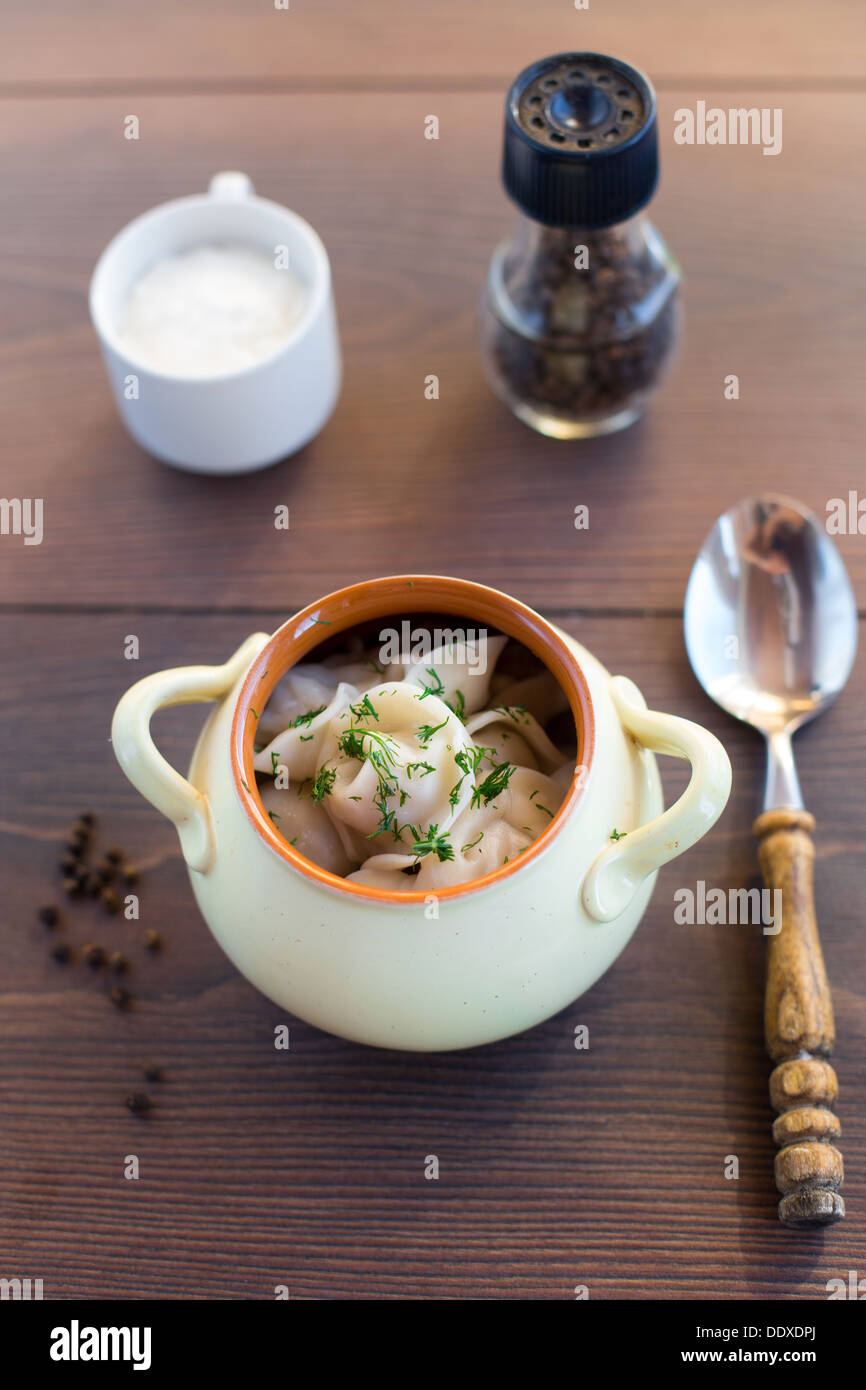 Fresh boiled meat dumplings served with dill Stock Photo - Alamy