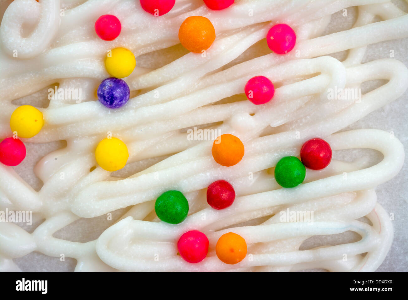 Colored candy balls on white lines and twists Stock Photo - Alamy