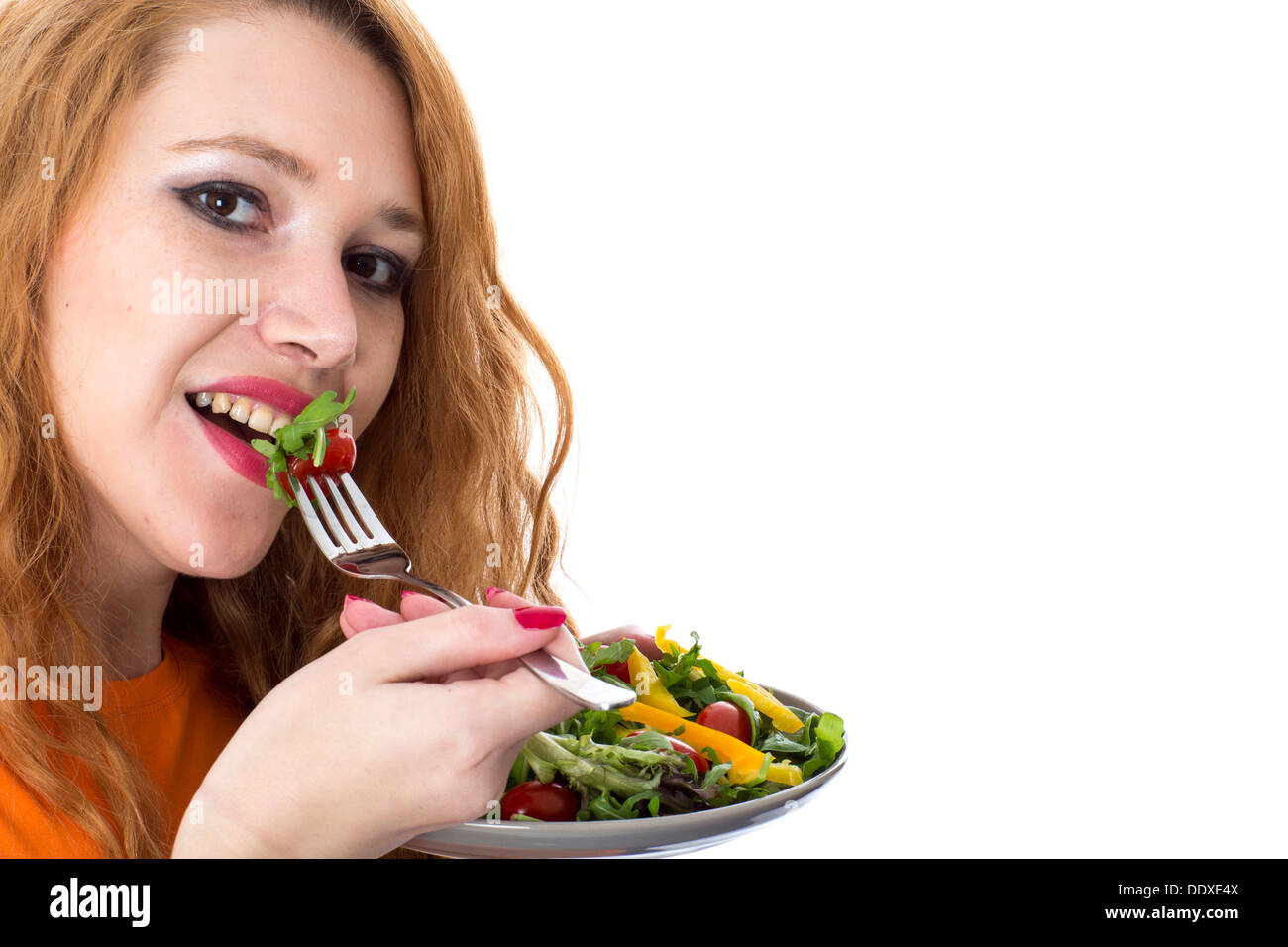 Model Released. Happy Young Woman Eating Salad Stock Photo - Alamy