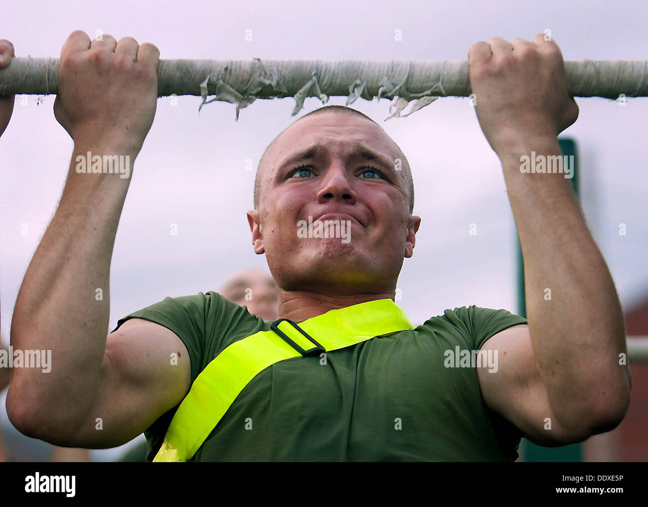 A 19-year-old Marine recruit strains at pull ups during training at ...