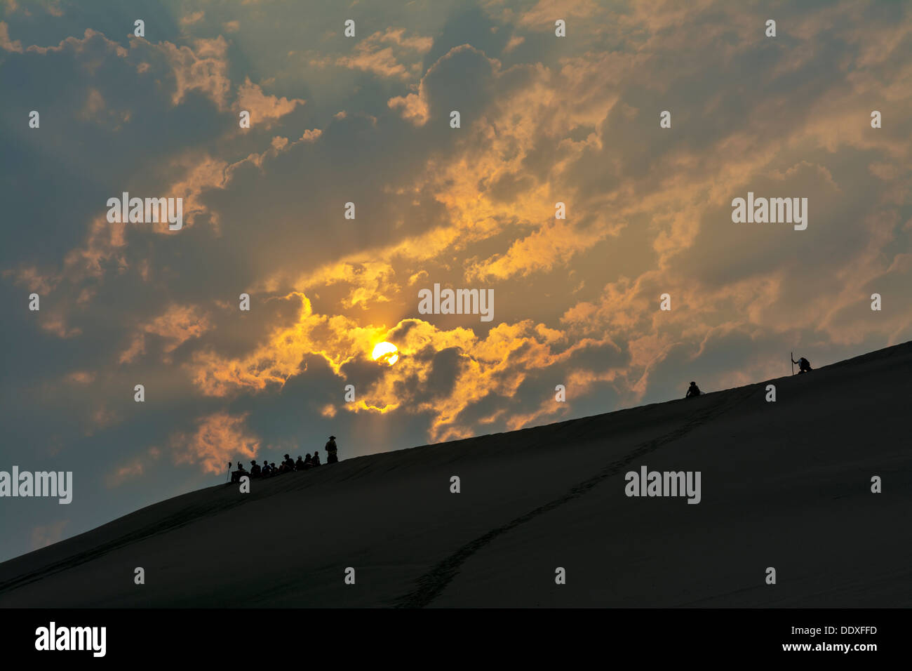 silhouette of people on a sand dune Stock Photo - Alamy