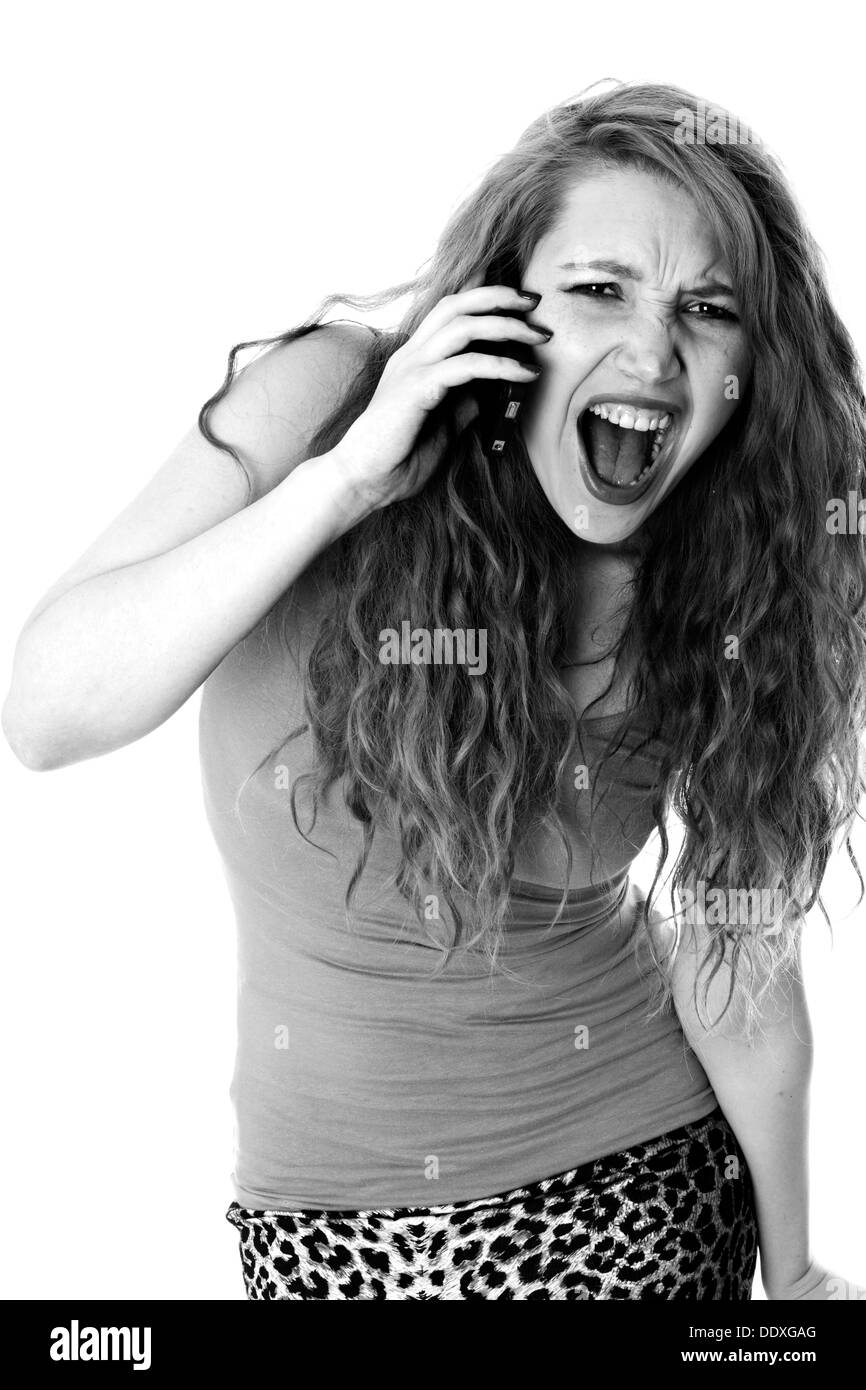 Model Released. Angry Young Woman Using Mobile Telephone Stock Photo ...