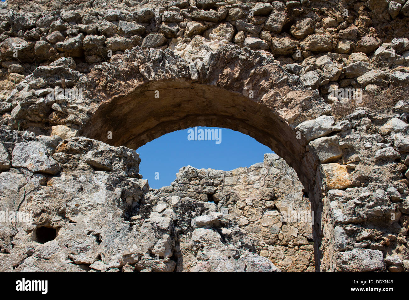 An arched doorway in the ruins of the city of Aptera in northern Crete ...