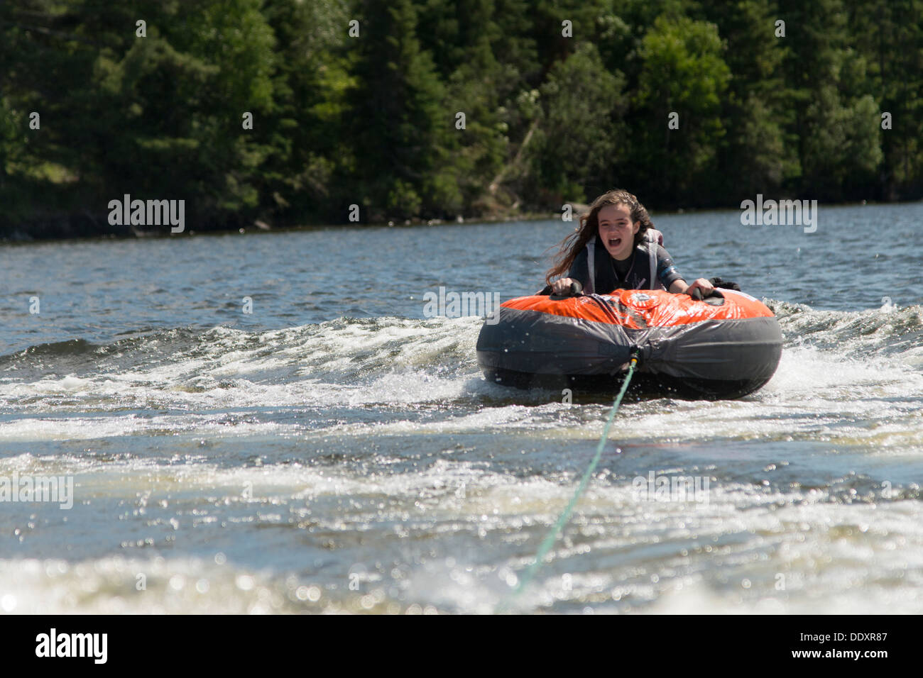 Girl enjoying on an inflatable raft, Lake of The Woods, Keewatin ...