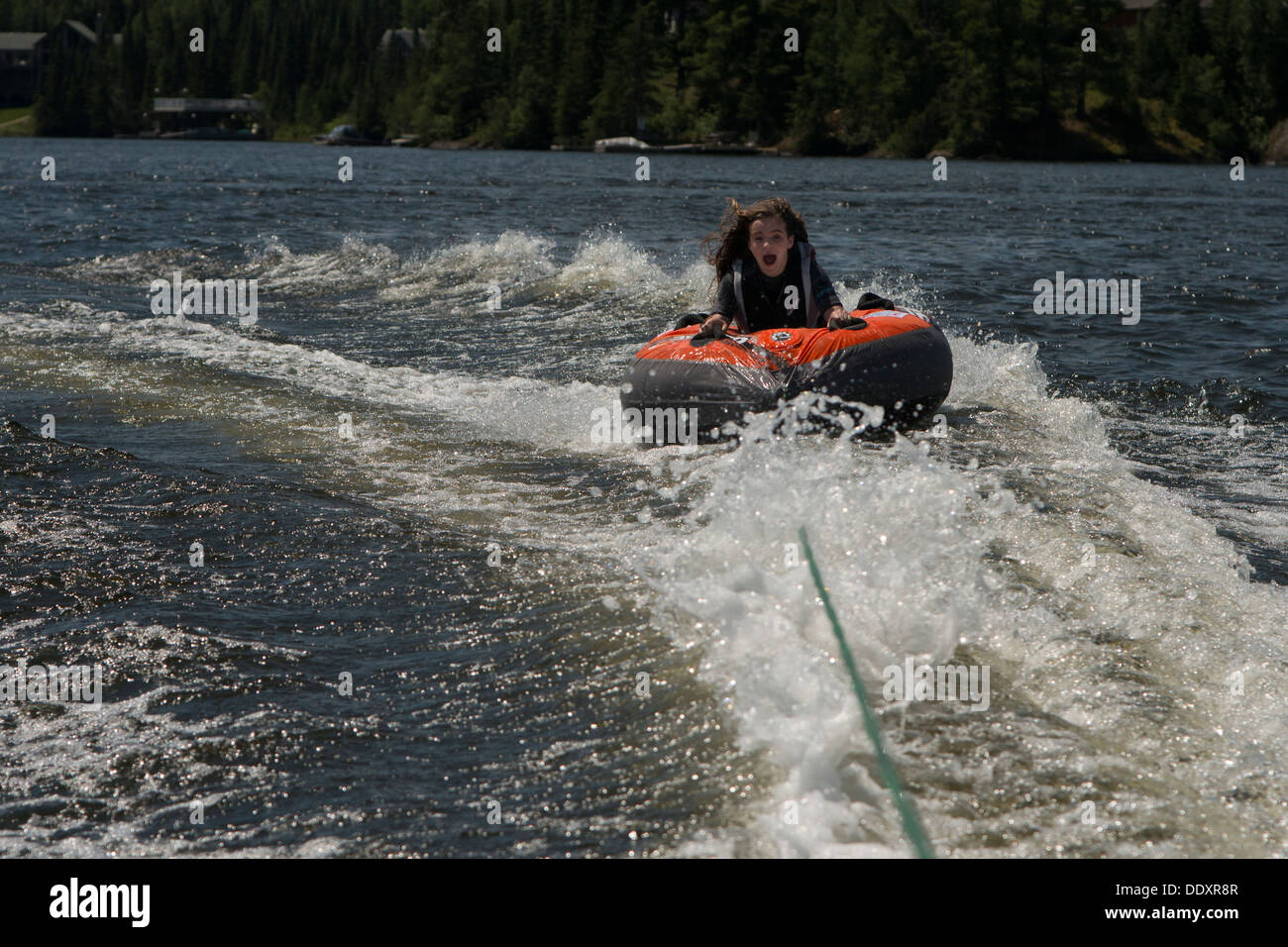 Girl on an inflatable raft, Lake of The Woods, Keewatin, Ontario ...
