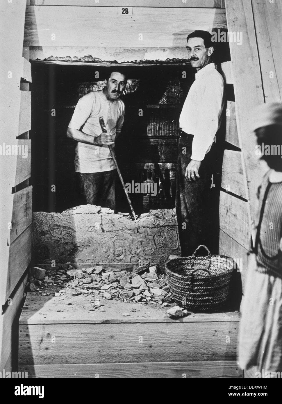 Howard Carter and a colleague excavating a tomb in the Valley of the ...