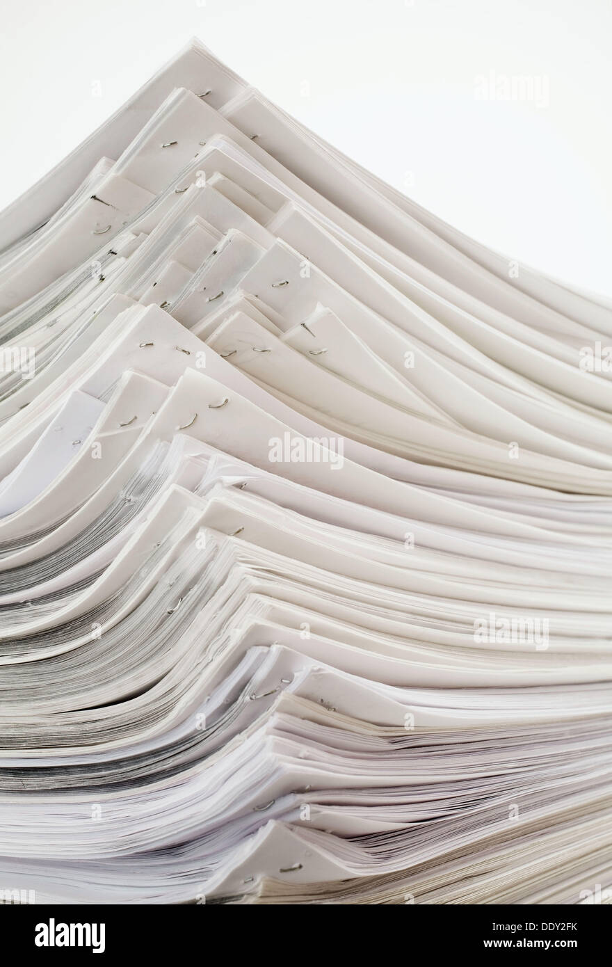 Stack of stapled white sheets of office paper on a white background ...