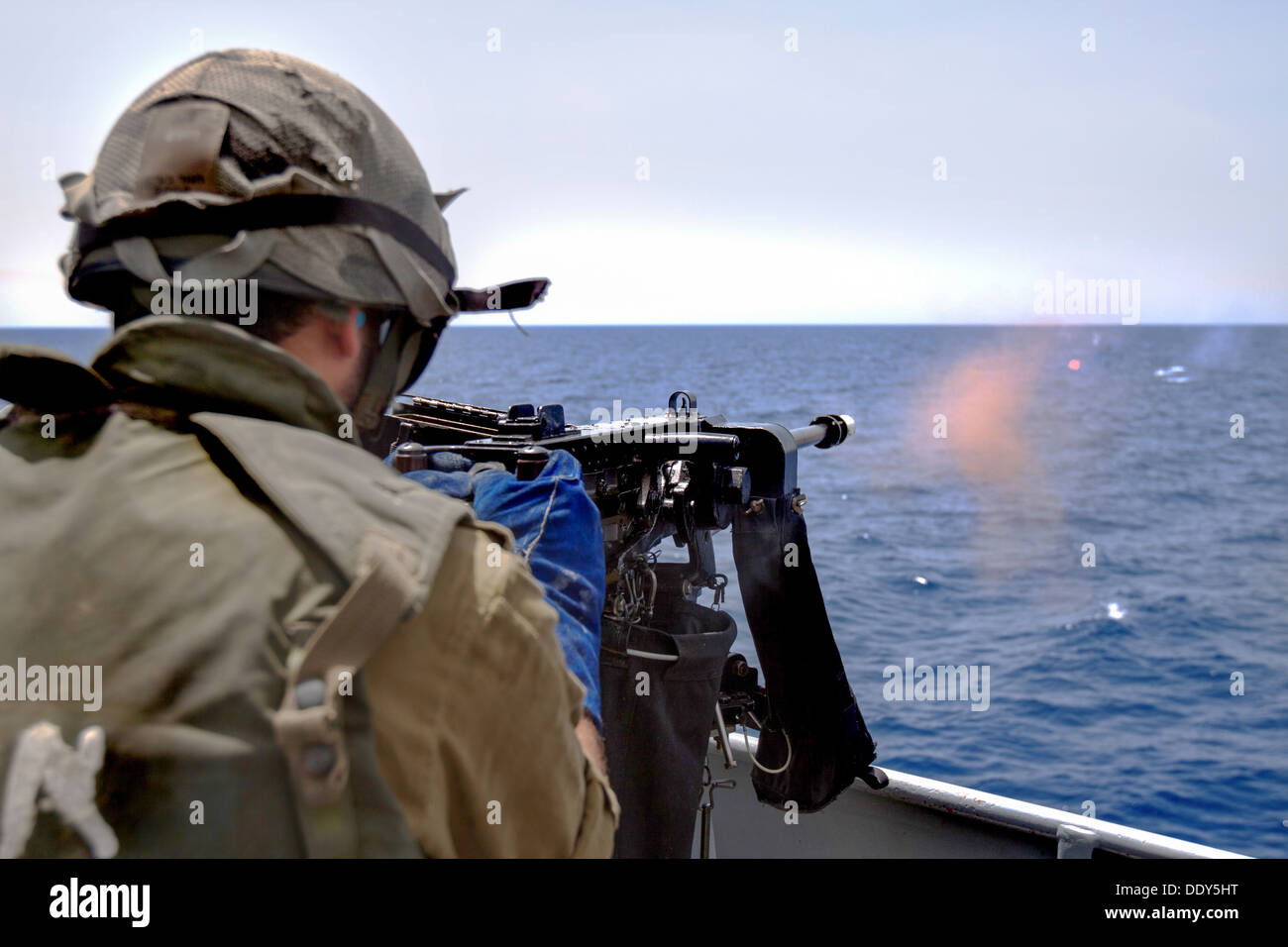 Israeli Navy missile boat class Saar 4.5 Soldier firing a machine gun ...