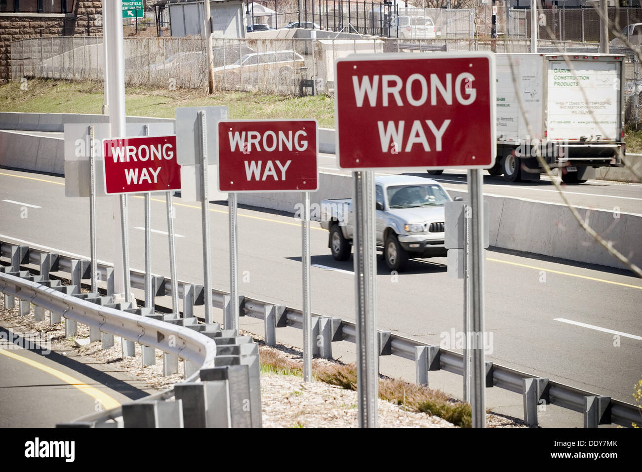 Multiple traffic signs reading ´Wrong Way´ near the exit of a highway ...