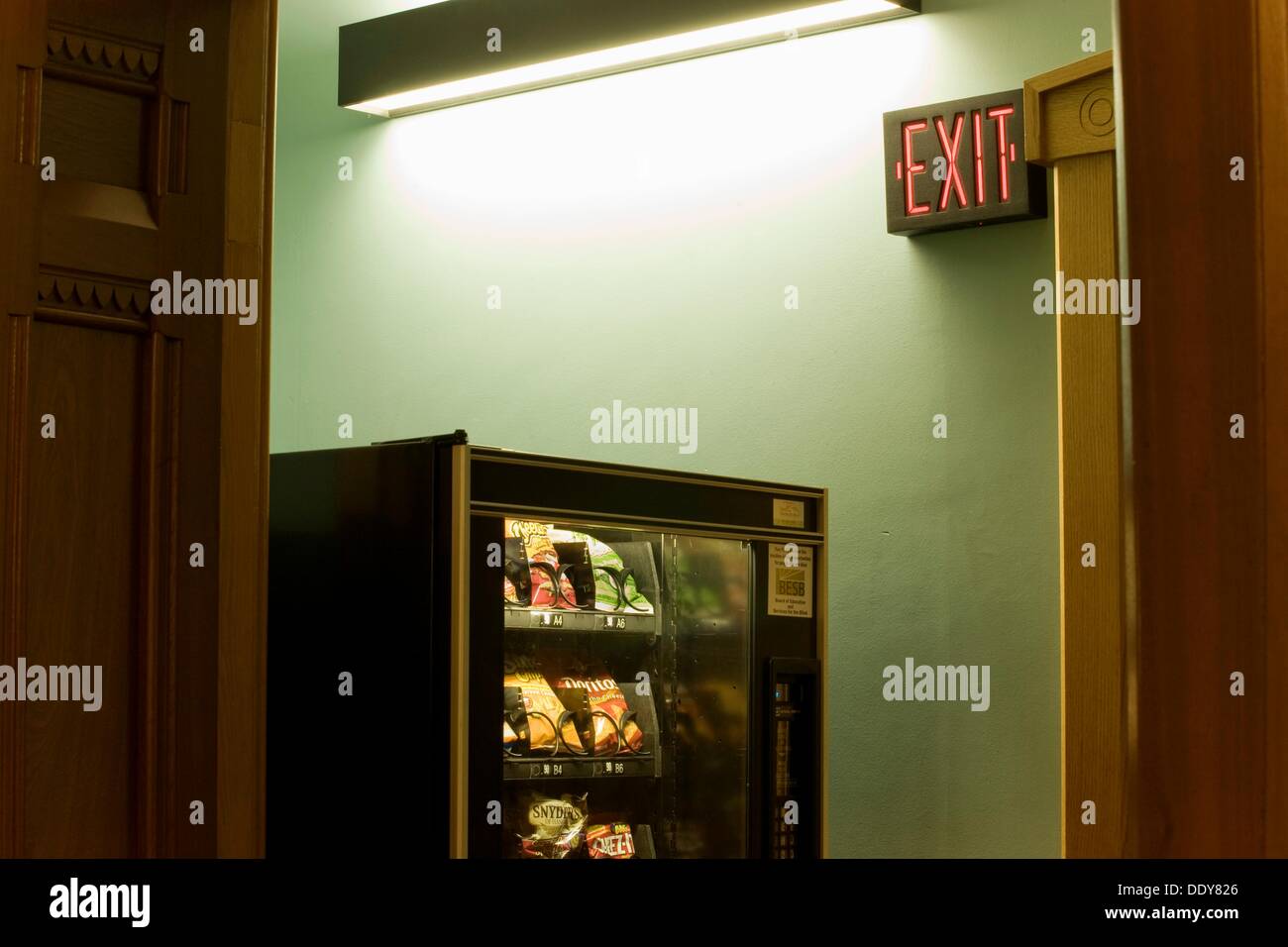 Vending machine and an exit sign in an office building Stock Photo - Alamy