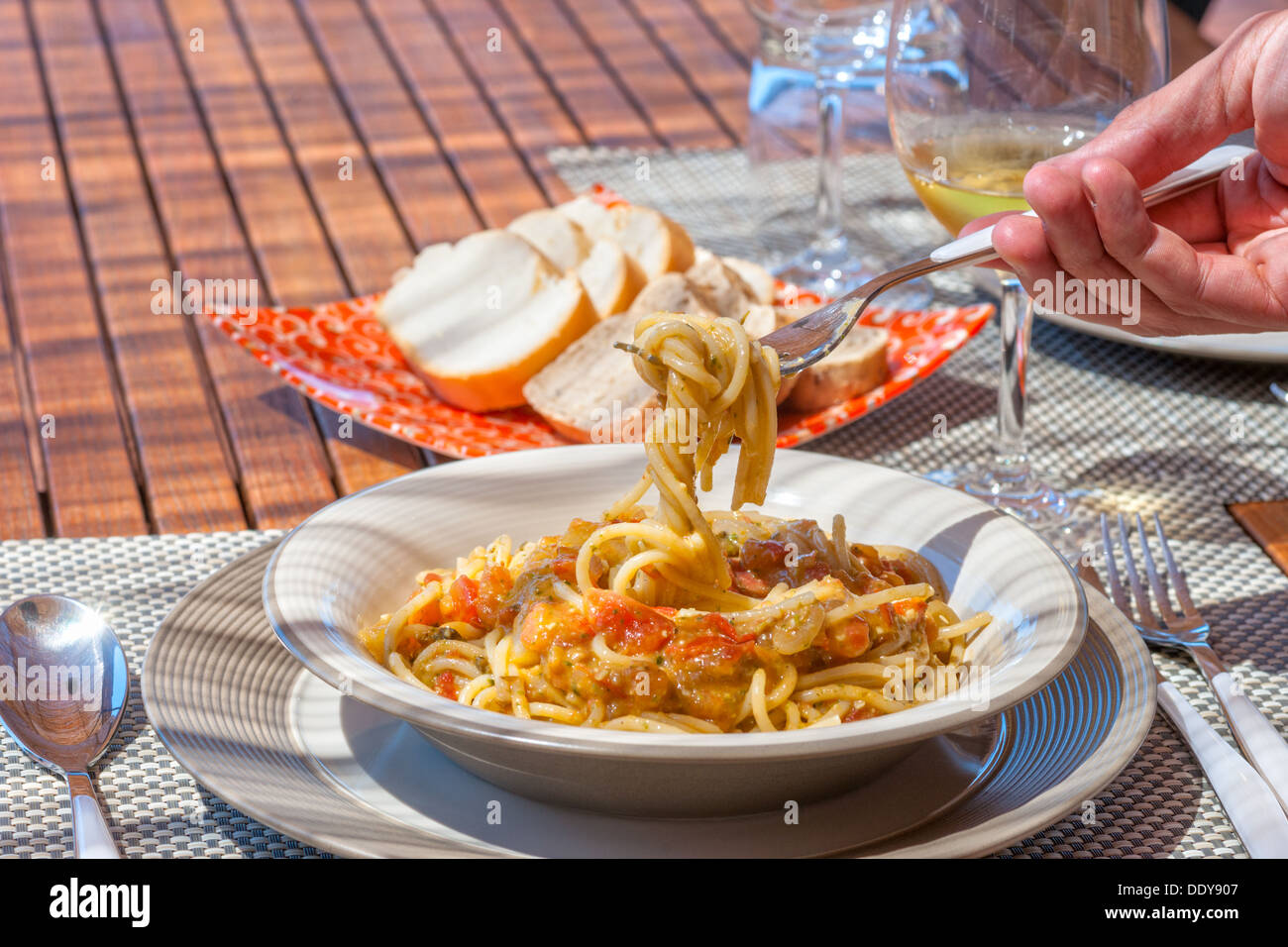 Spaghetti in a Teak wood table Stock Photo - Alamy
